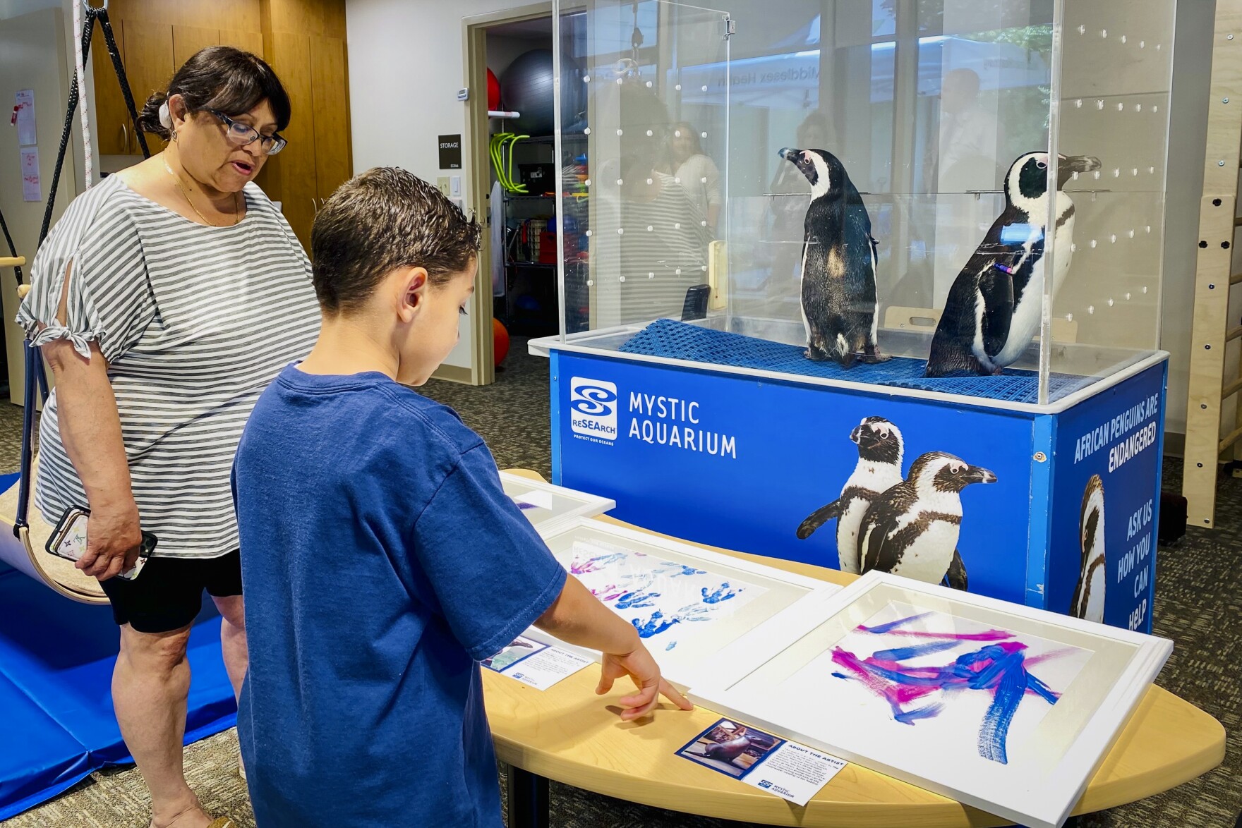 Mystic penguins present penguin-made art to children with autism ...